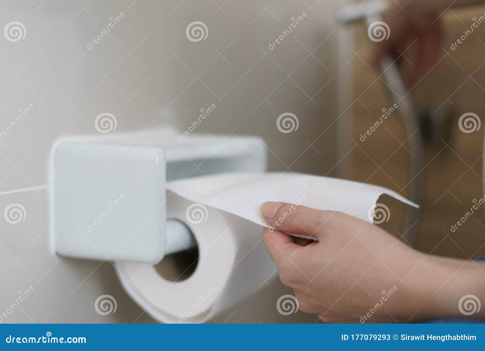 Hand Pulling a Roll of Toilet Paper Tissue Stock Image - Image of ...