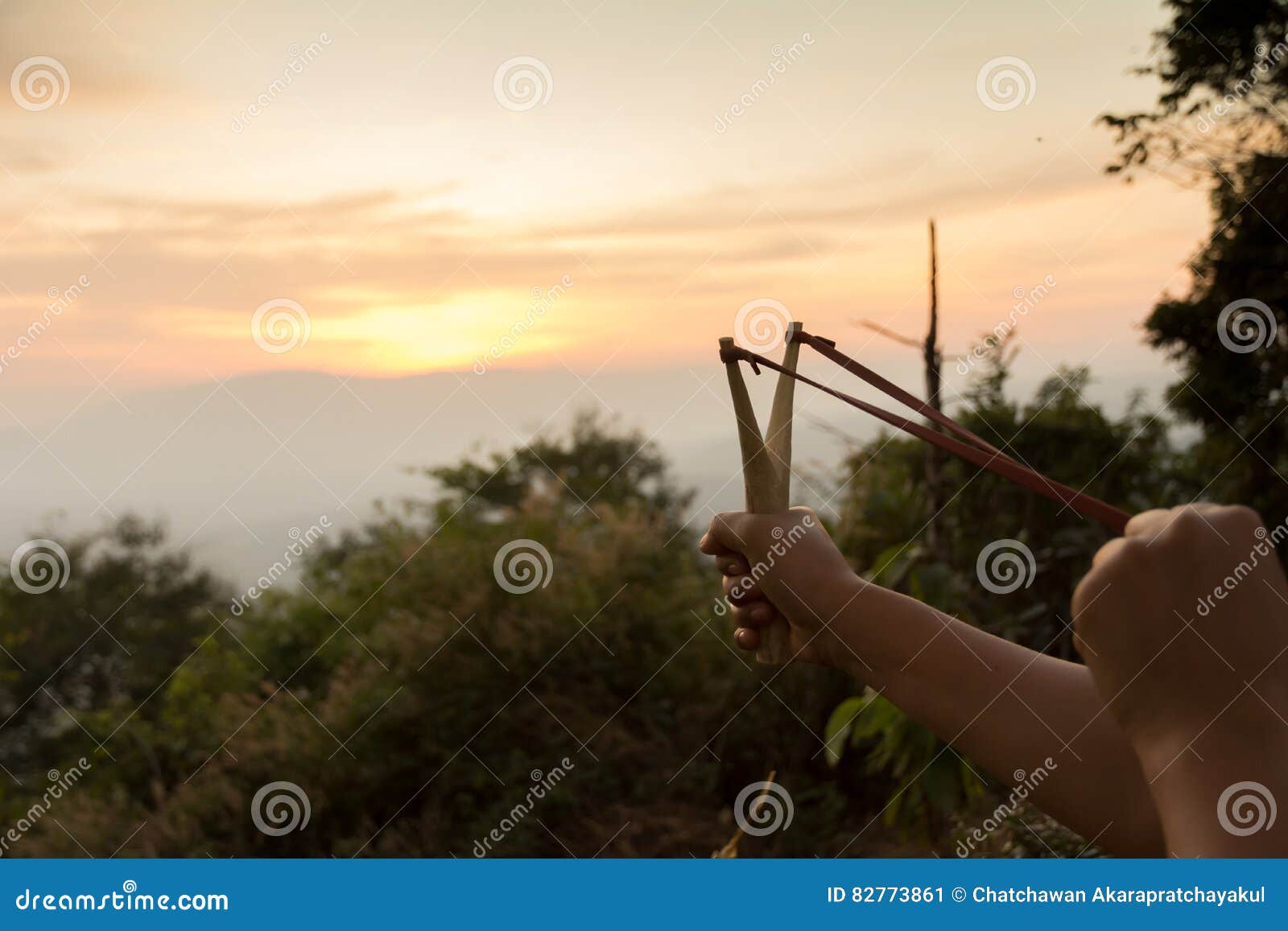 Hand Pulling Slingshot Preparing To Shot during Sunset Time Stock Image ...