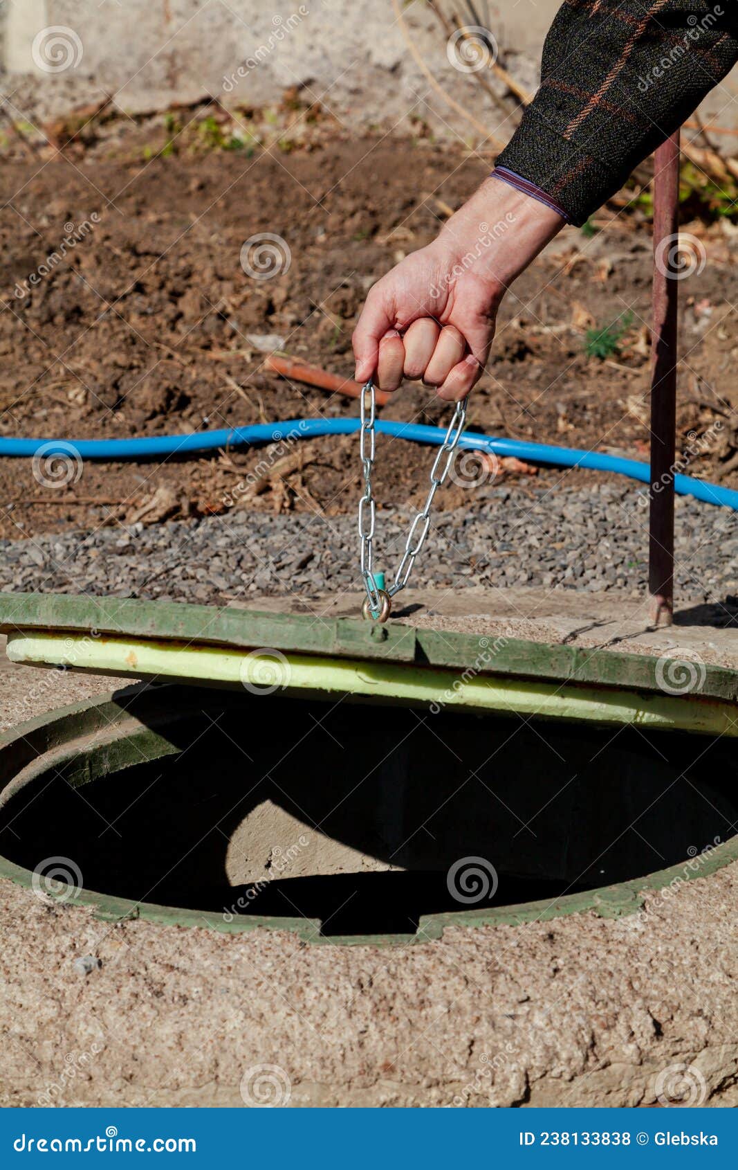 Hand Opens Sewer Hatch in Yard Stock Photo - Image of access, round ...