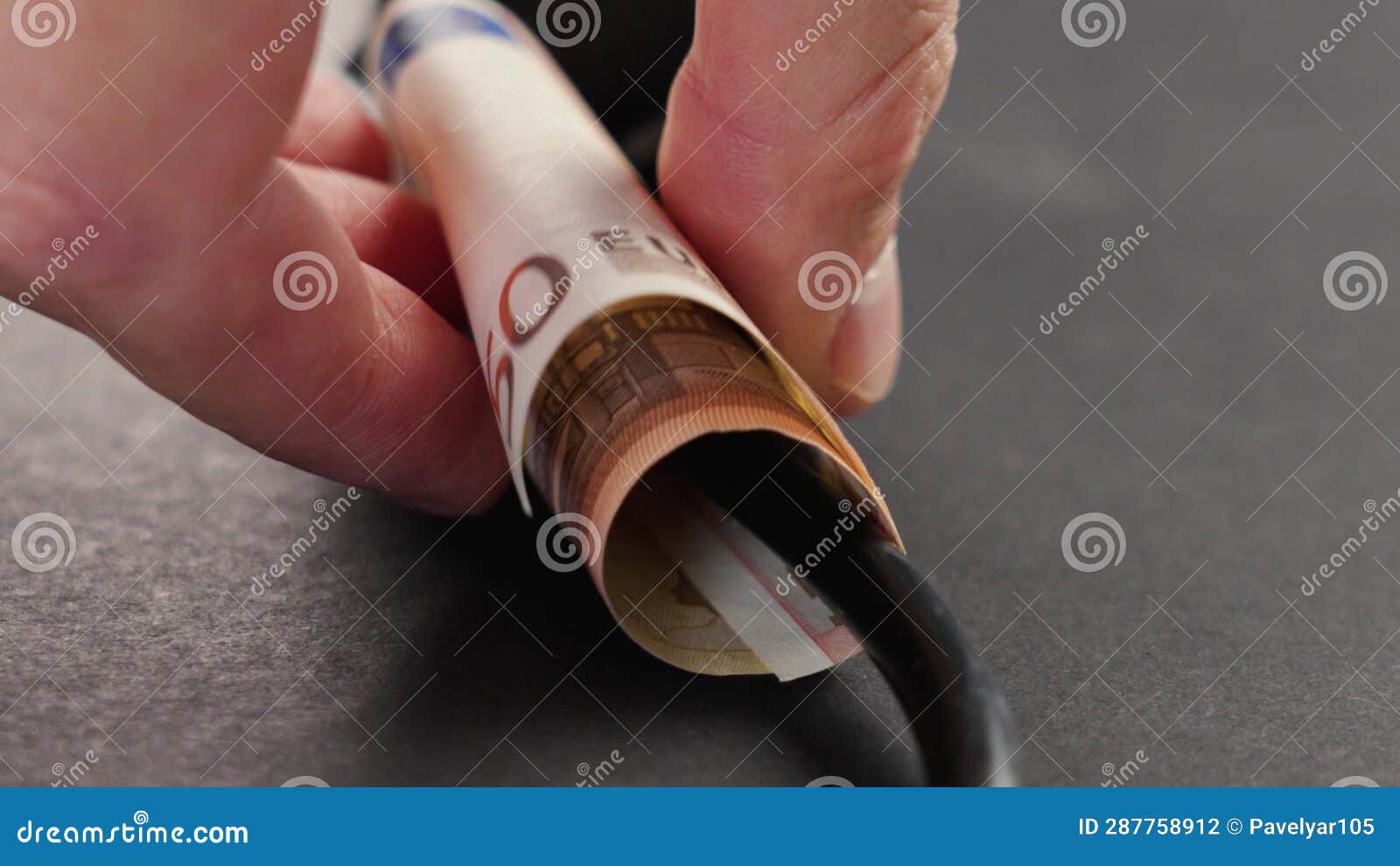 A Hand Pulls Out a Euro Banknote Twisted Around an Electrical Cord ...