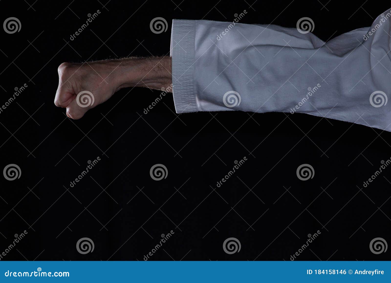 Hand Punch Performed by an Athlete Against a Dark Background Stock ...