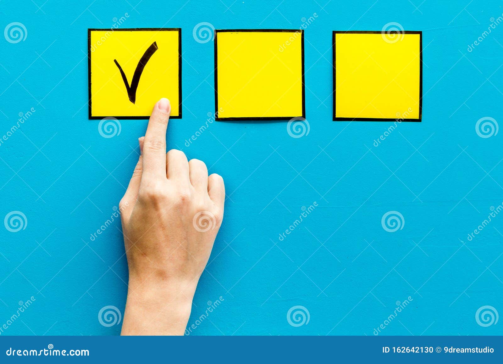 Hand Put Check Mark in Yellow Check-box on Blue Background Top View ...