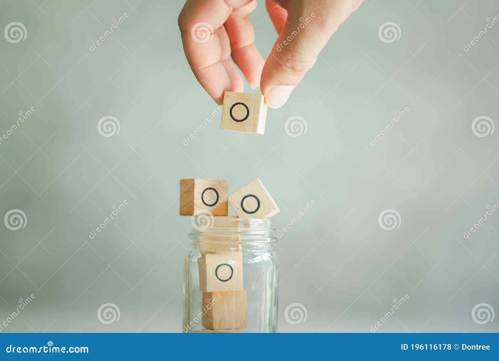 Hand Put O Symbol Wooden Cube into Glass Cup Stock Photo - Image of ...