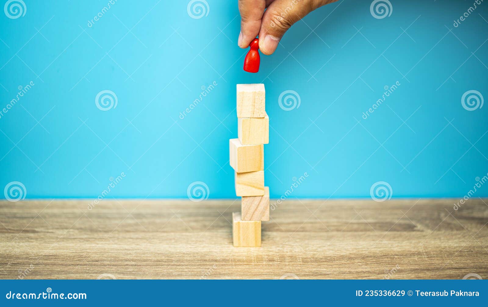 Hand Put Red Pin To the Brown Cubic Stack on the Table and Blue ...