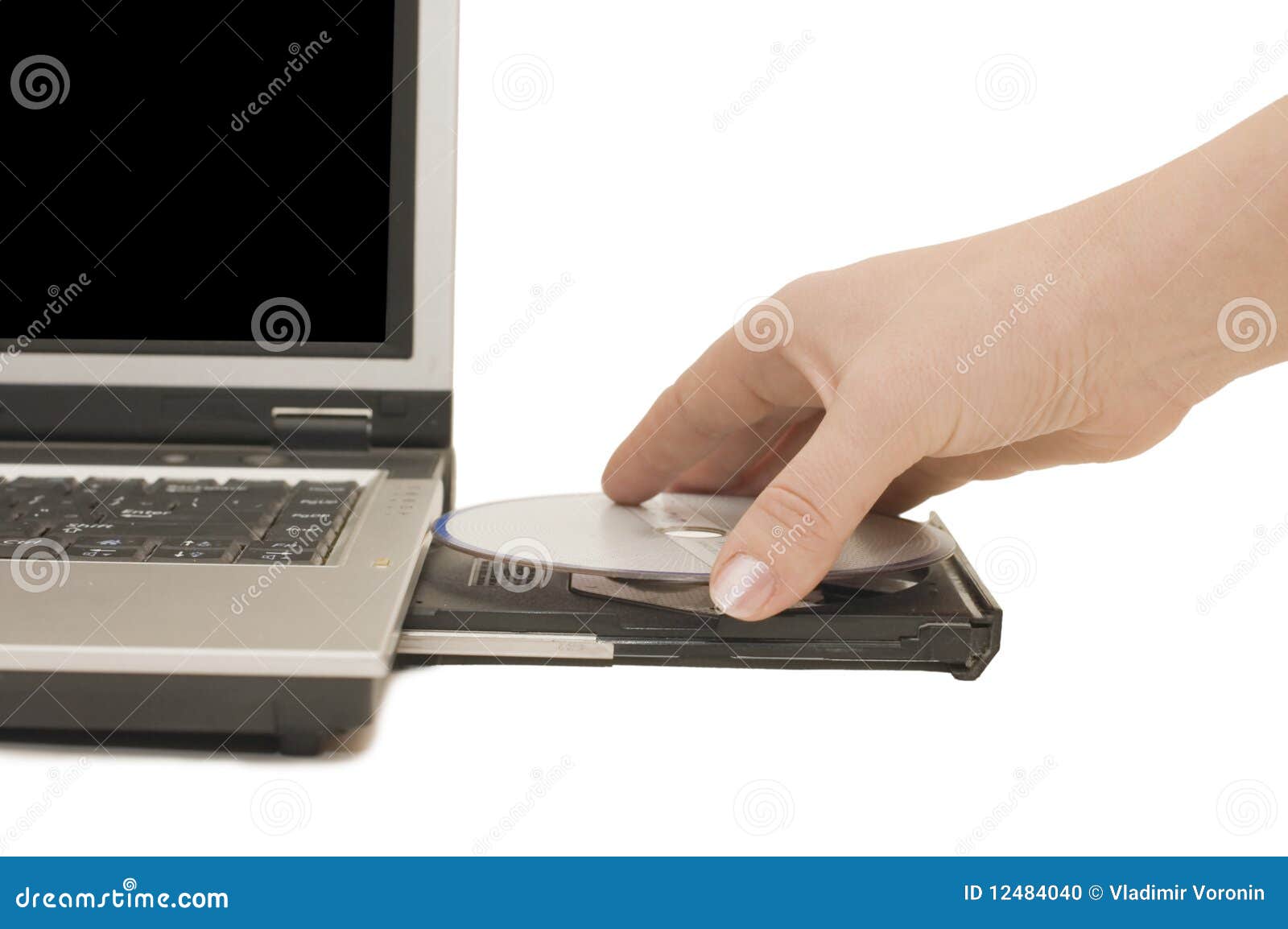 Hand puts a disk in laptop stock photo. Image of carrying - 12484040