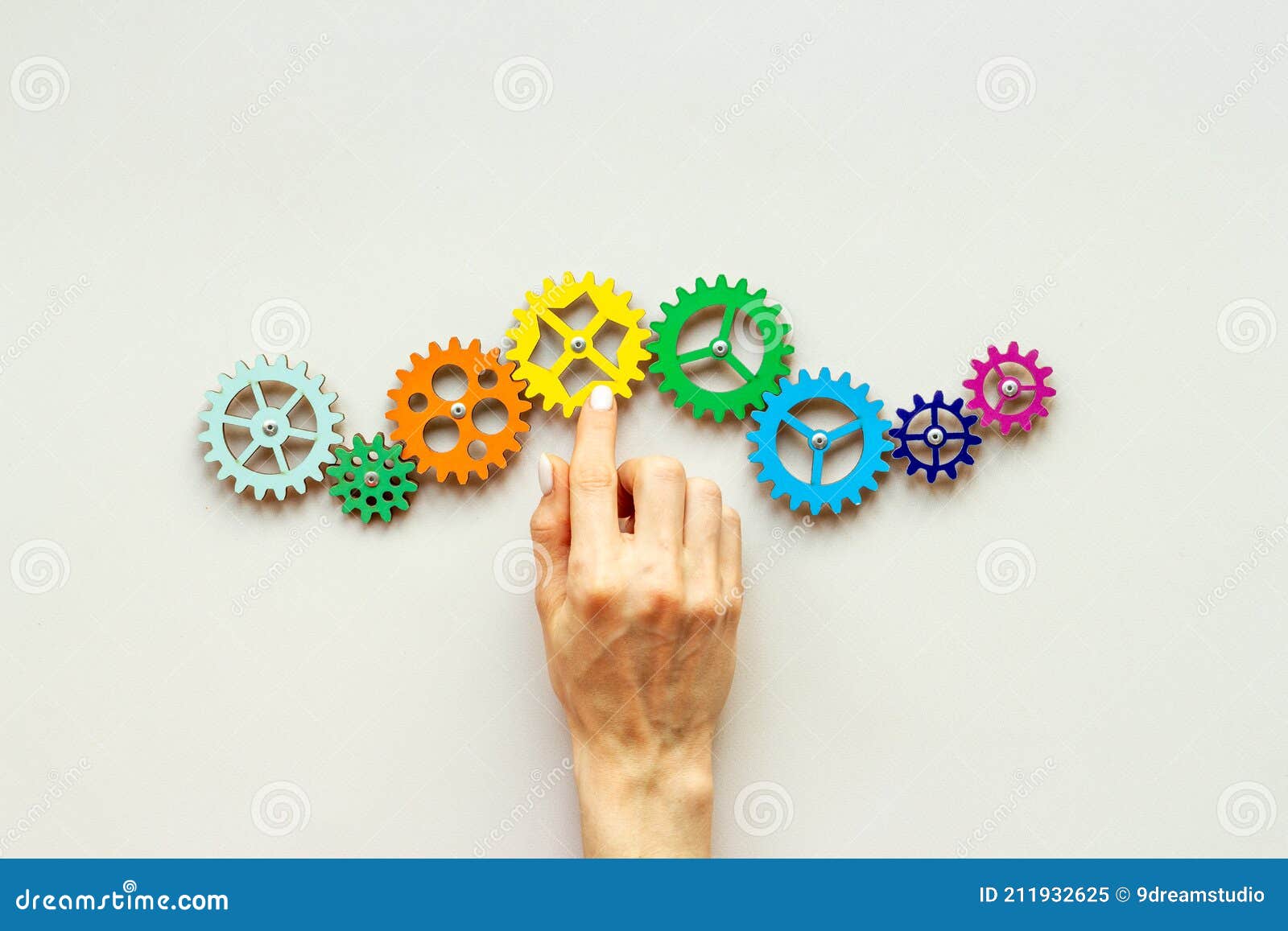 Hand Puts a Gear into One Working Mechanism. Teamwork and Collaboration ...