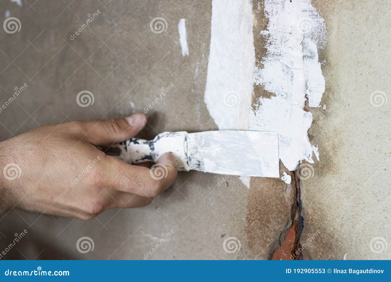 A Hand Puts Putty Paste on the Wall. Sealing of Walls Stock Image ...