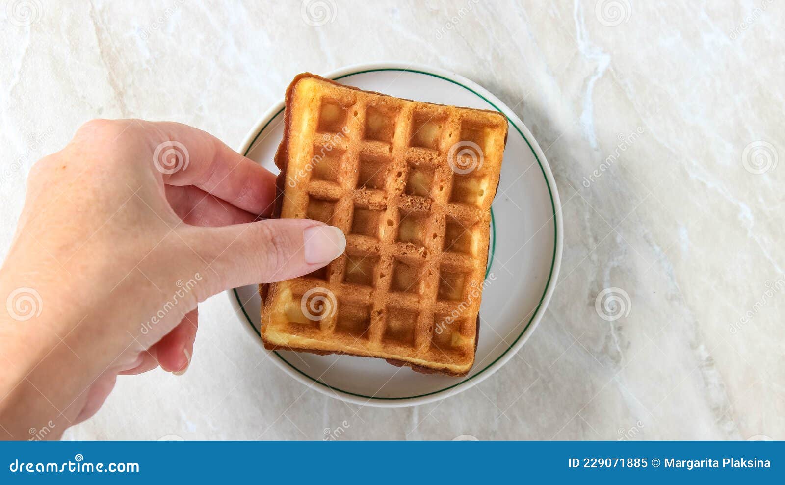 The Hand Puts Soft Rectangular Waffles on a Saucer. Delicious Dessert ...