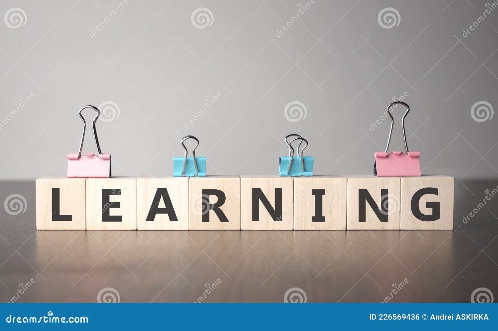 The Hand Puts a Wooden Cube with Sign Learning. the Word is Written on ...