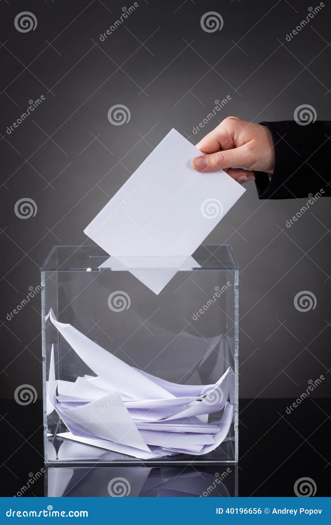 Hand putting ballot in box stock photo. Image of political - 40196656