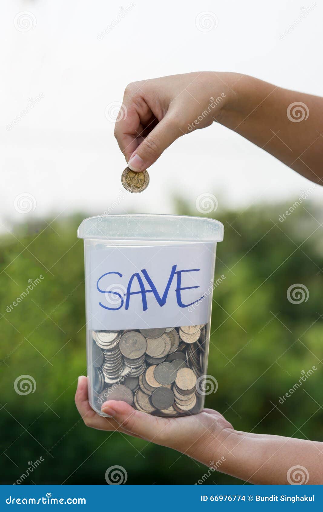 Hand putting coin into jar stock photo. Image of dollar - 66976774