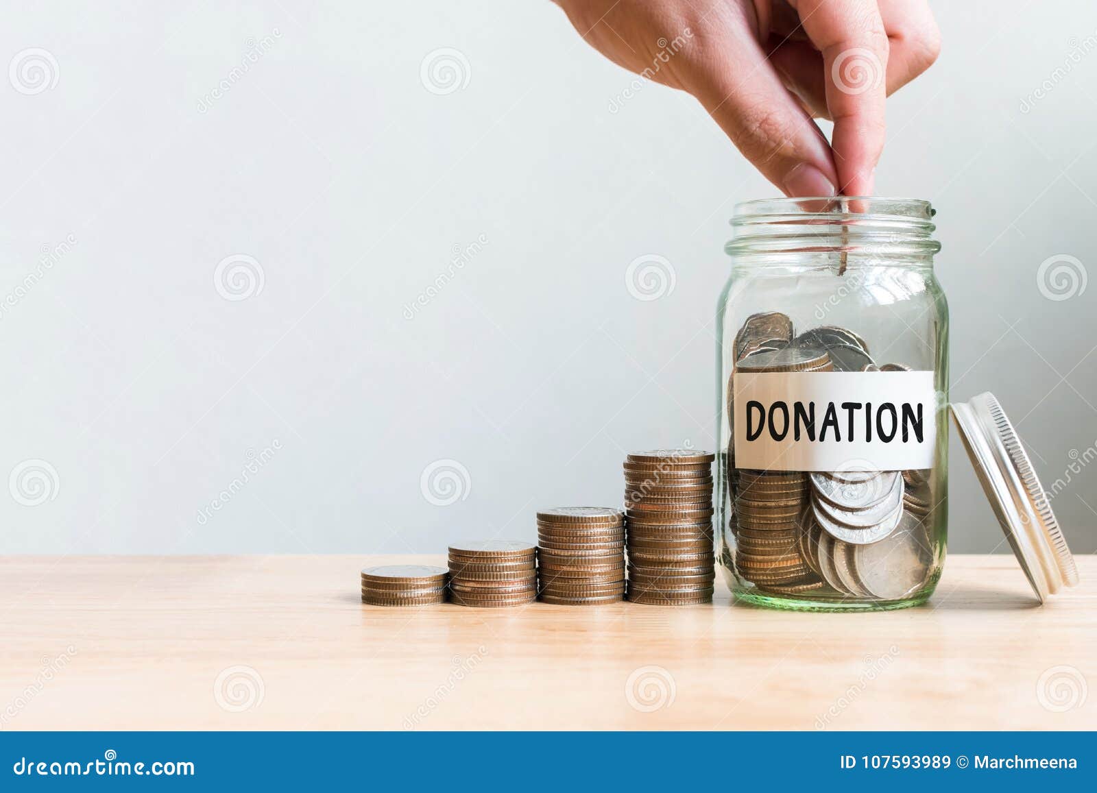 Hand Putting Coin in Jar Word Donation with Money Stack, Concept Stock ... Hand Putting Coin in Jar Word Donation with Money Stack, Concept Stock ...