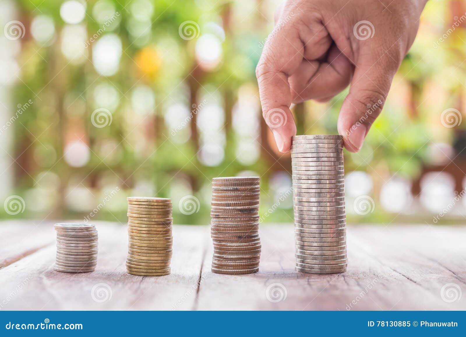 Hand Putting Coins in Stack on Wooden Plank. Savings Concept Stock ...
