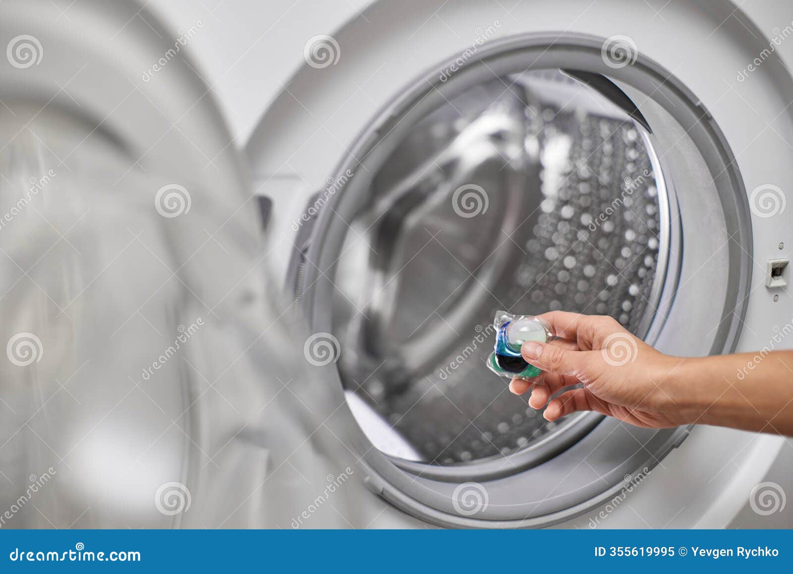 Hand Putting Laundry Detergent Capsule into Washing Machine Stock Image ...