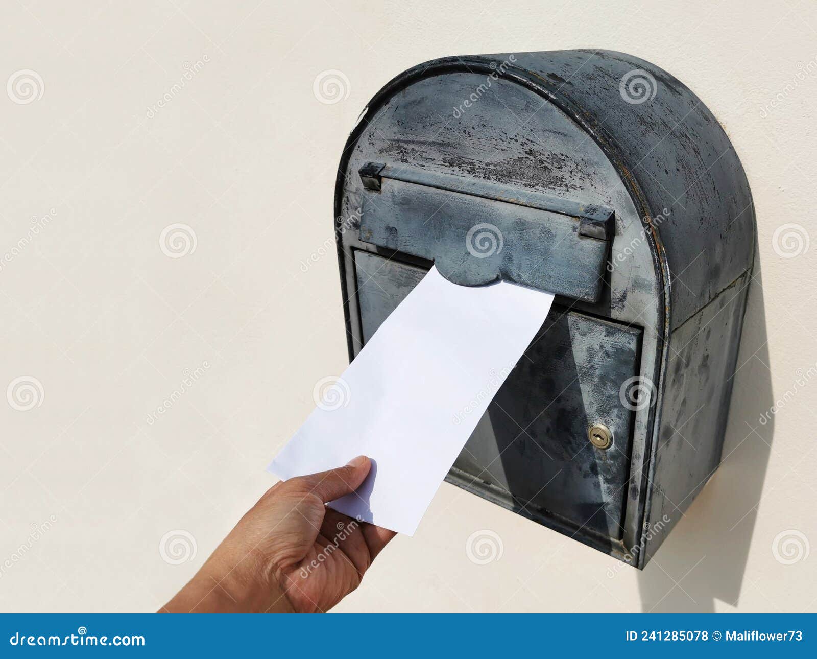 Hand Putting a Letter in the Mailbox with Copy Space on the Left Side ...