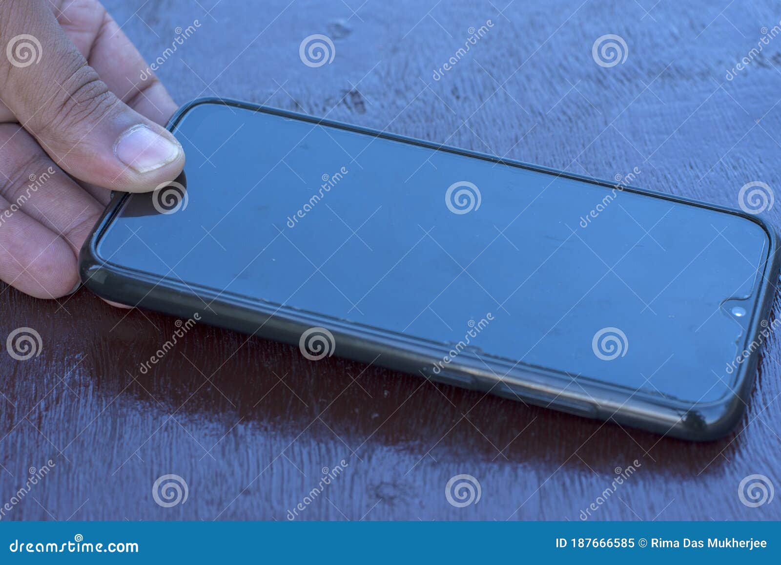 A Hand Putting a Mobile on Table Stock Image - Image of holding ...