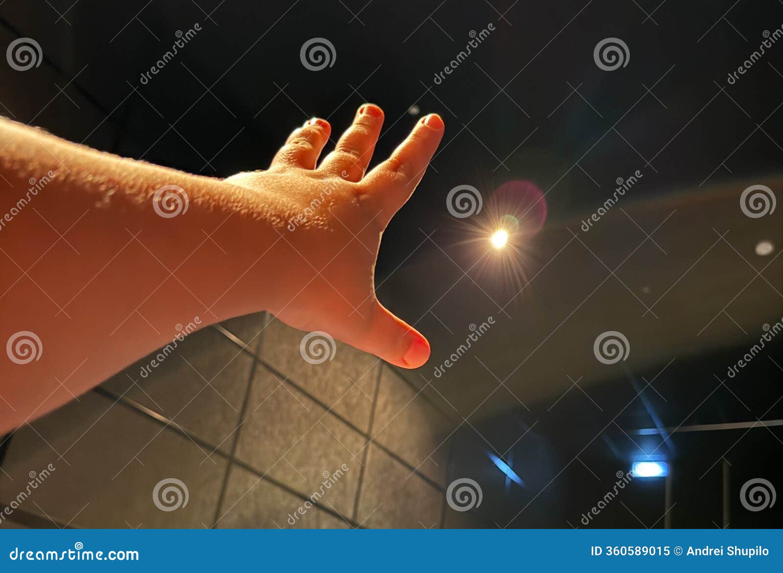 A Hand is Raised in the Air with a Light Shining on it Stock Image ...