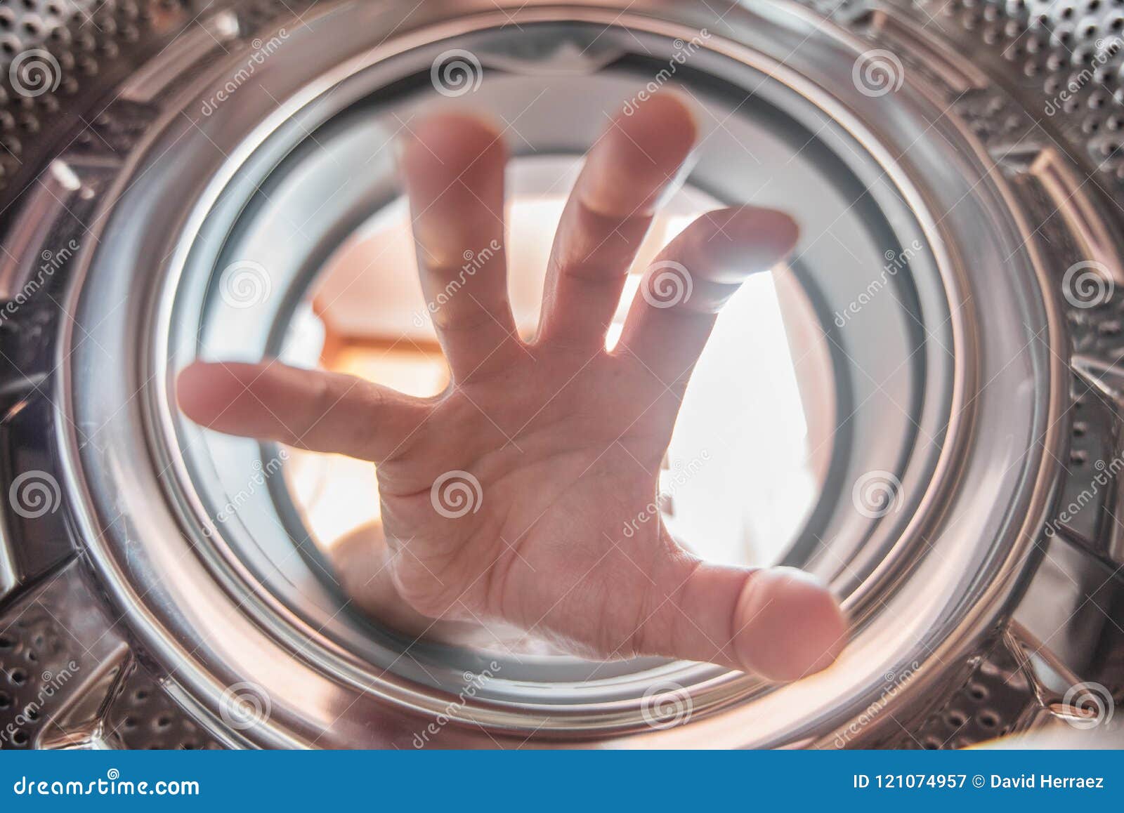 A Hand is Reaching Clothes Inside the Washing Machine. Stock Image ...
