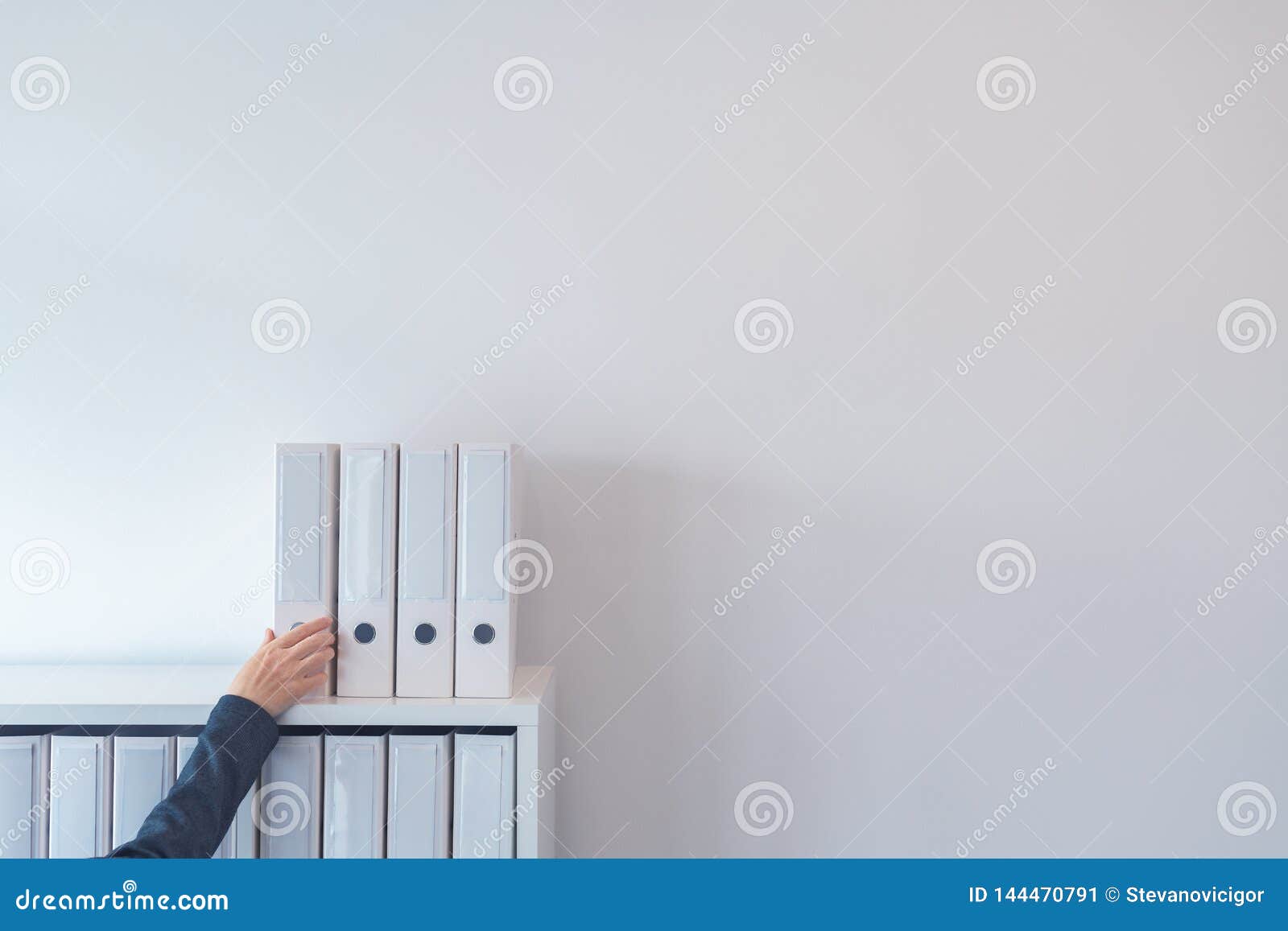 Hand Reaching for Document Ring Binder on Office Shelf Stock Image ...