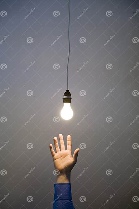 Hand Reaching for Light Bulb Stock Image - Image of hand, idea: 5112603