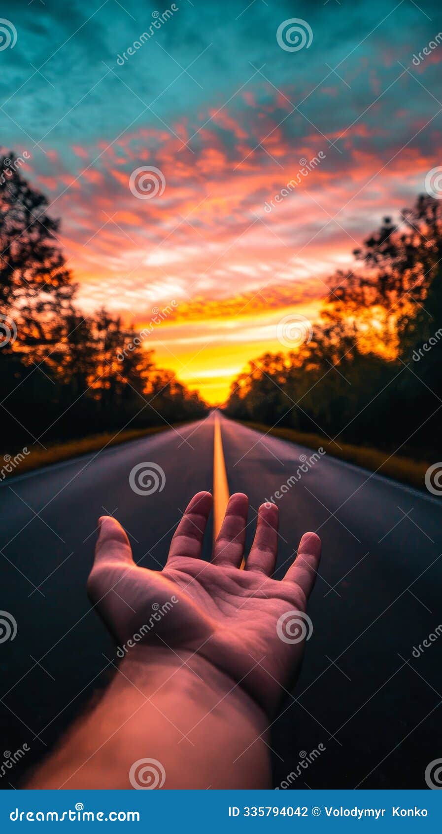 Hand Reaching Out Towards Vibrant Sunset on Open Road Stock Photo ...