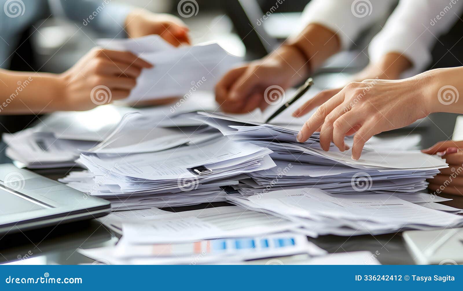 Hand Reaching for Paper on a Stack of Papers on a Desk Stock ...