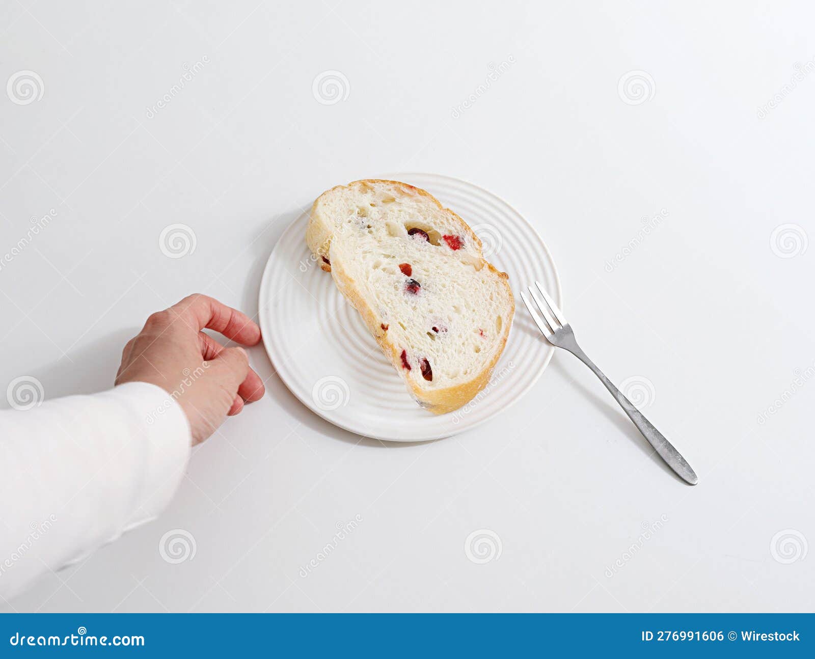 Hand Reaching for a Piece of Bread on a Plate Stock Photo - Image of ...