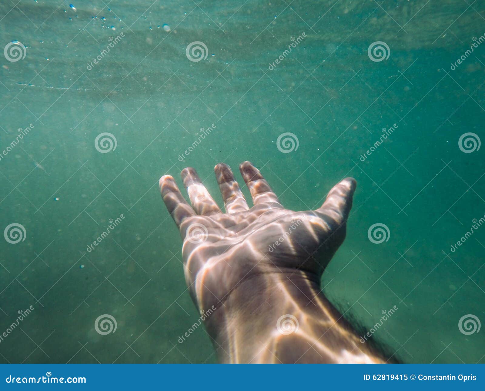 Hand reaching underwater stock image. Image of green - 62819415