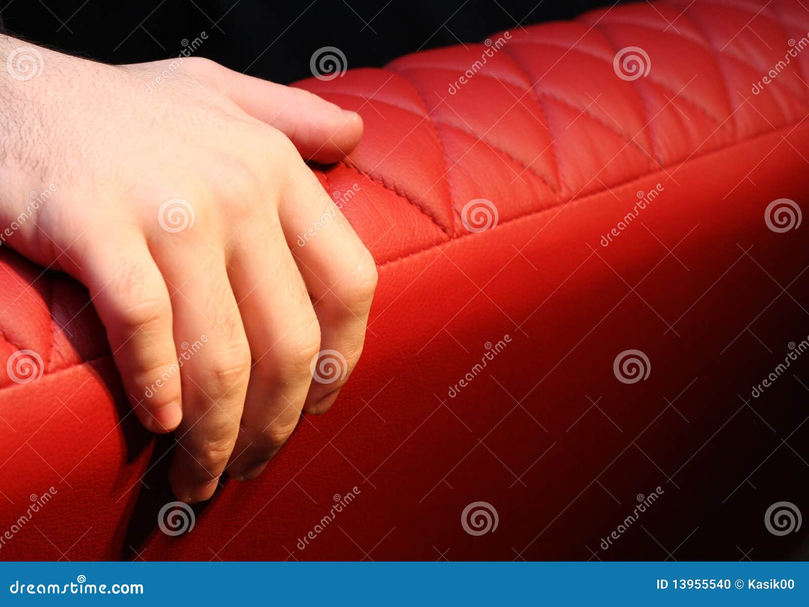Hand on red leather sofa stock photo. Image of seating - 13955540
