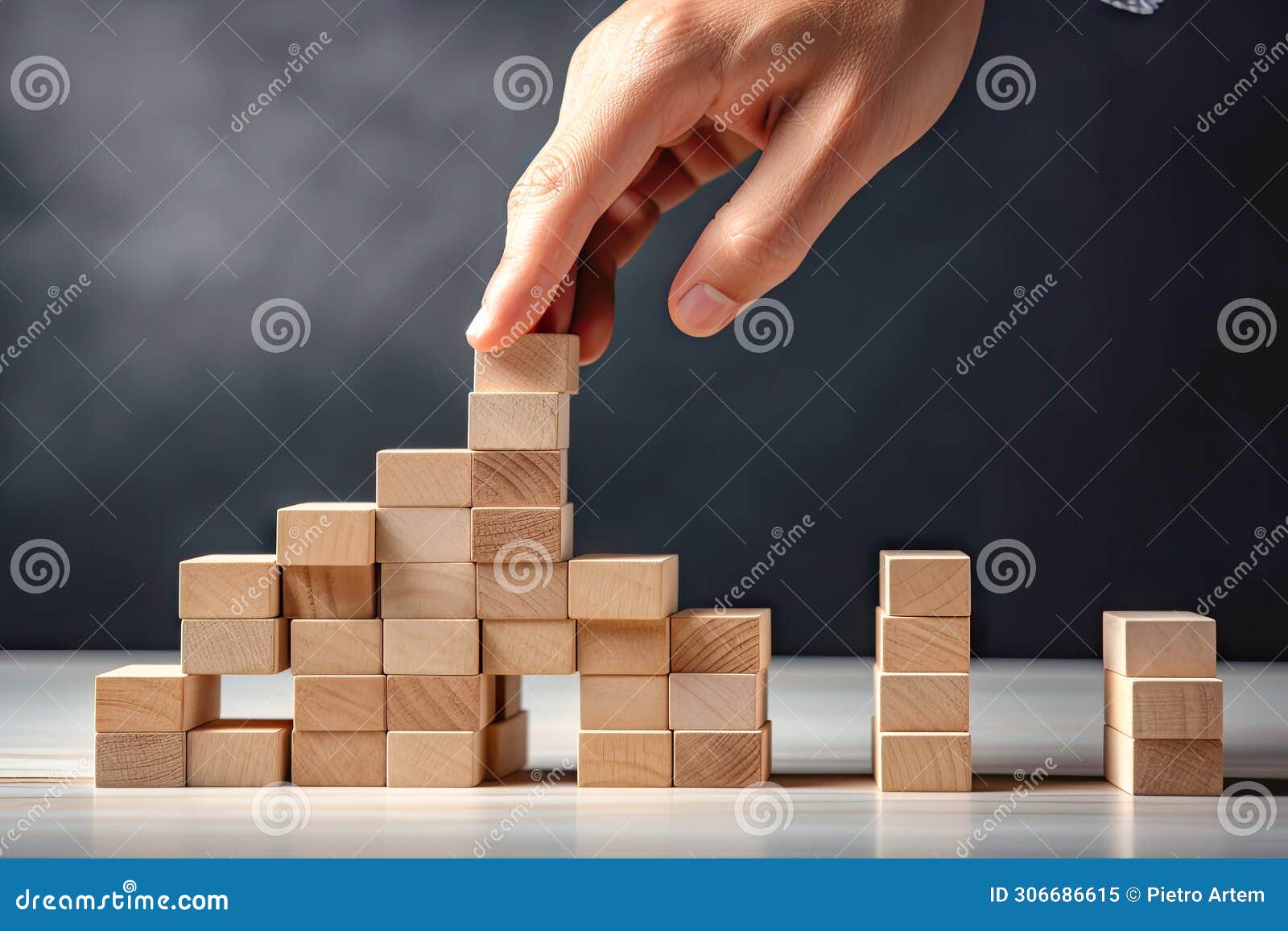 Hand Removing Wooden Blocks from Different Heights Stock Image - Image ...
