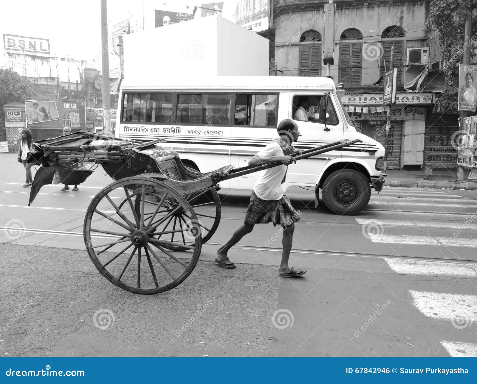 A Hand Rickshaw Puller Pulls His Rickshaw in the Middle of the Road ...