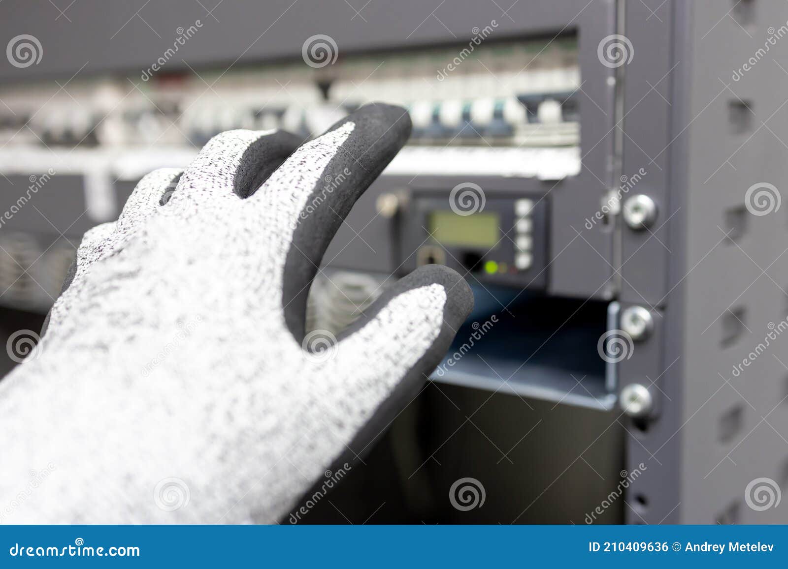 A Hand in a Rubberized Glove Reaches for a Group of Switches Stock ...