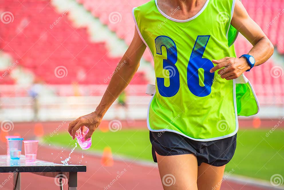 The Hand of the Runner Grabbing the Water Stock Photo - Image of ...