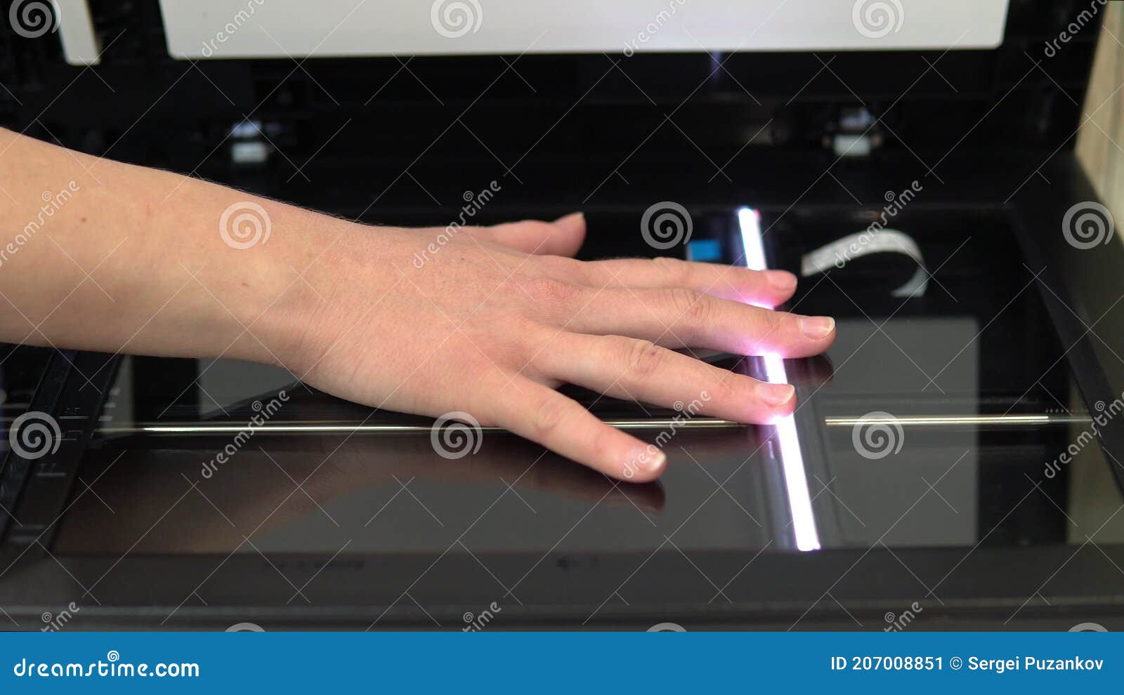 Hand Scanning Process. Scanner in Operation Scans a Human Hand with the ...