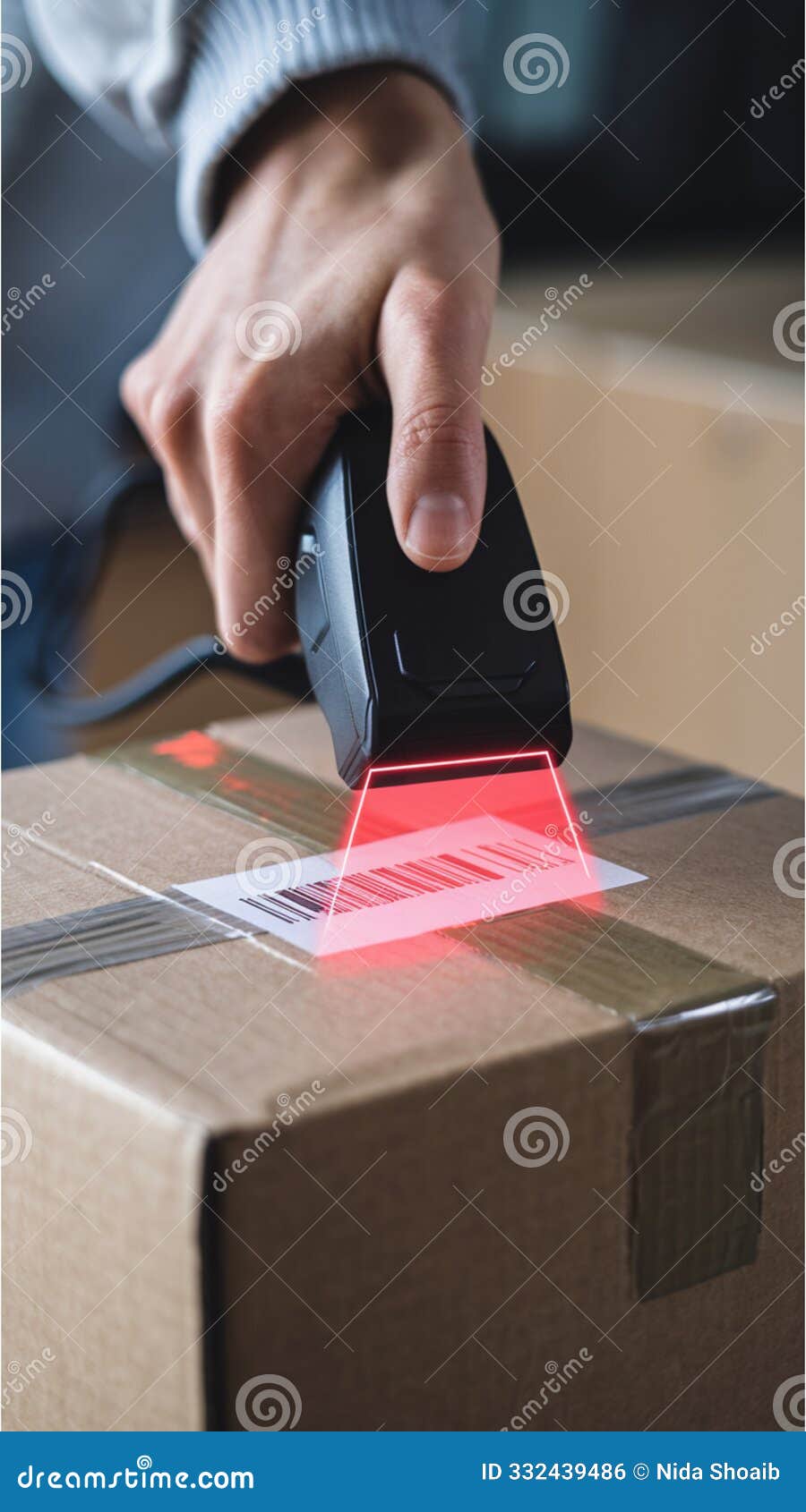 Hand Scans a Barcode on a Sealed Cardboard Box with a Barcode Scanner ...