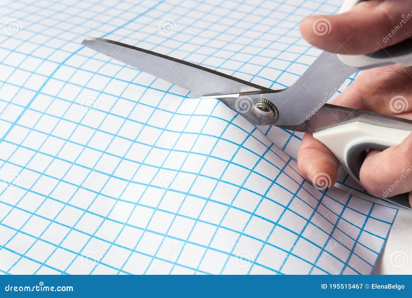 Hand with Scissors Cuts a Sheet of Graph Paper. Stock Image - Image of ...