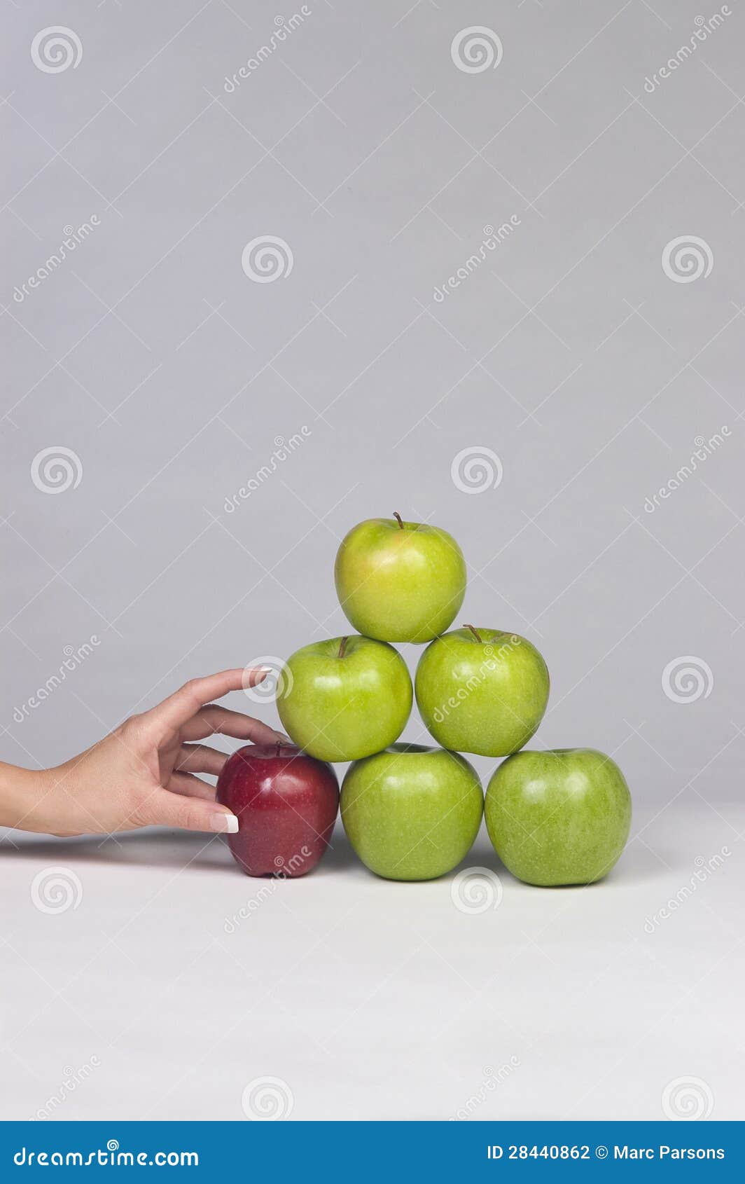 Hand Selecting an Apple from a Stack Stock Photo - Image of choices ...