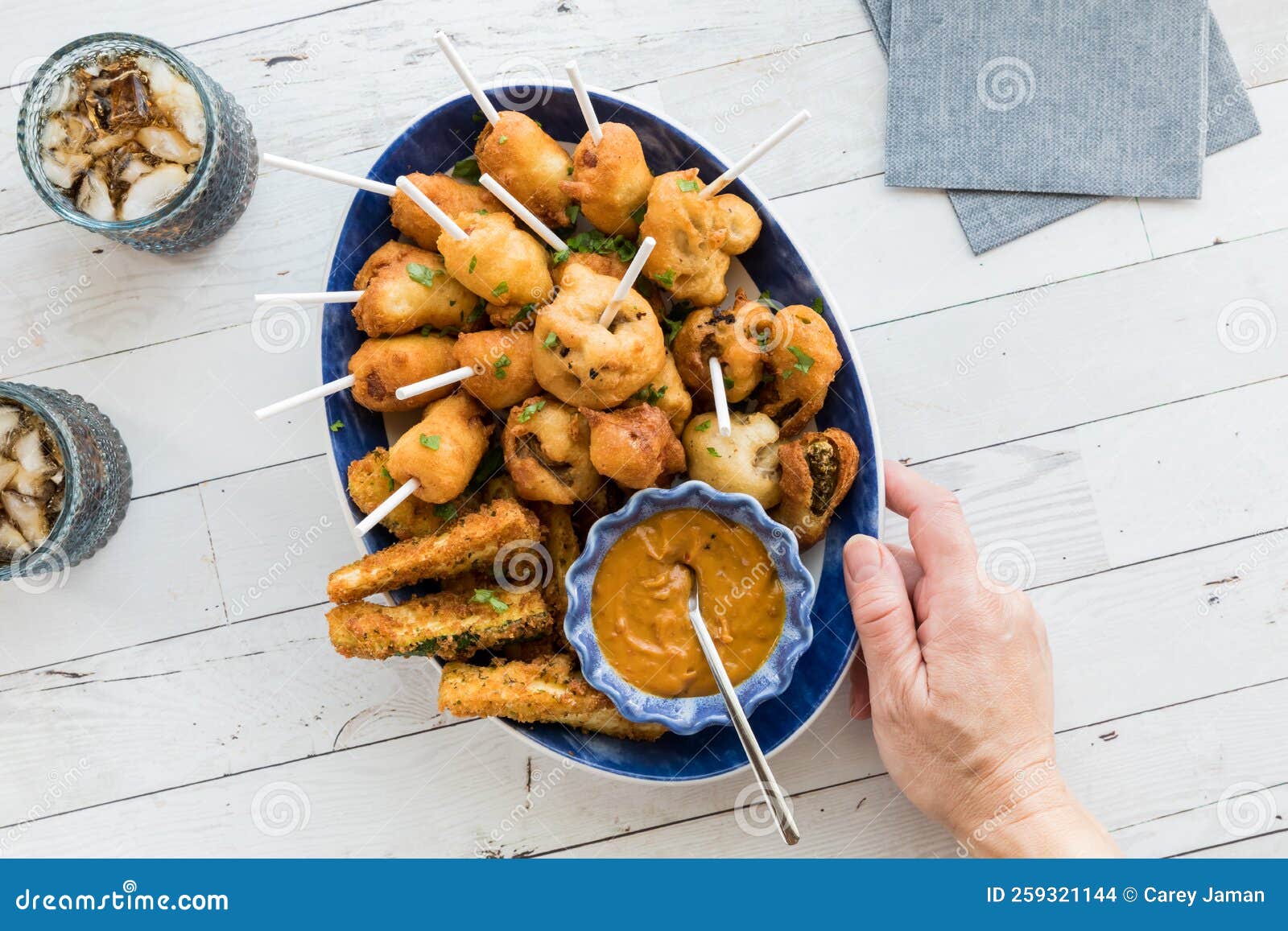 A Hand Serving a Platter of Deep Fried Appetizers, for Sharing. Stock ...