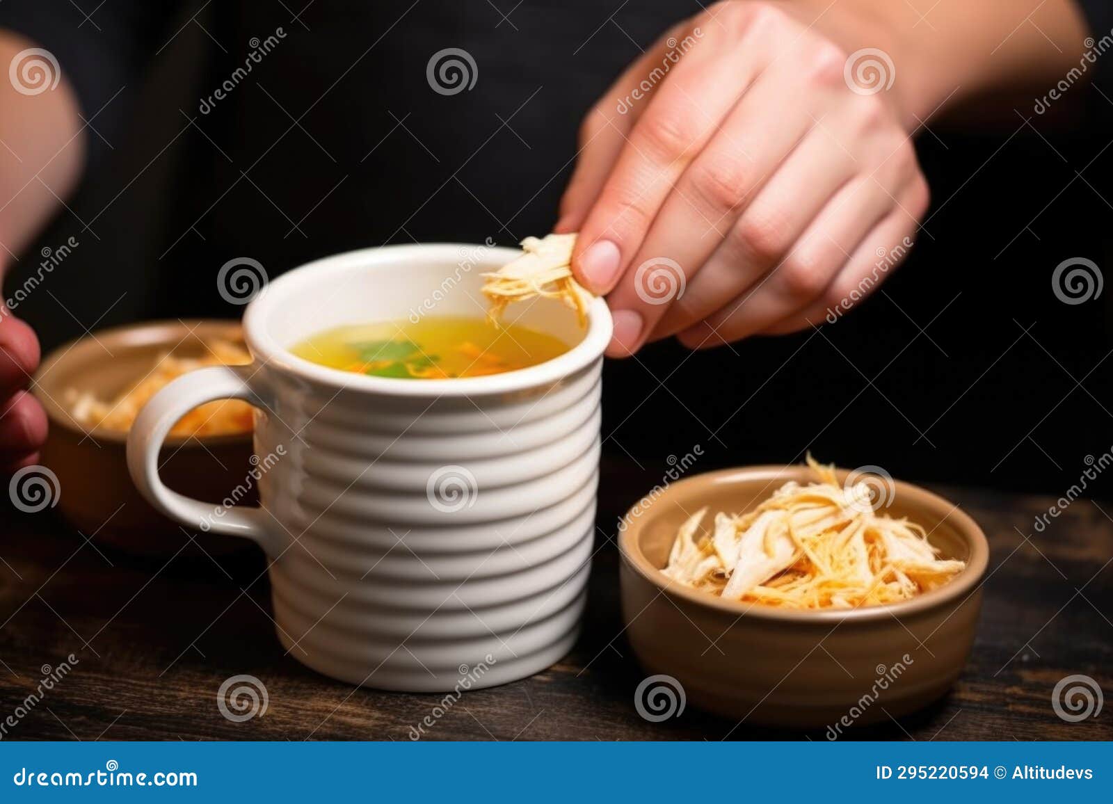 Hand Serving Soup with Shredded Chicken into Ceramic Cup Stock Photo ...