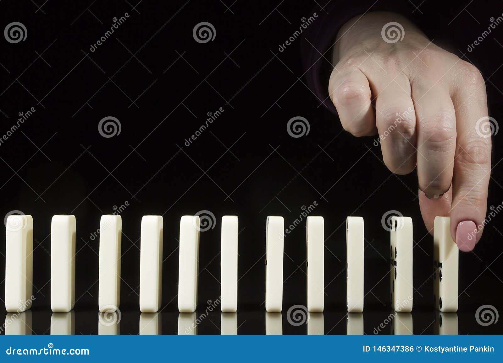 The hand sets the dominoes stock photo. Image of domino - 146347386