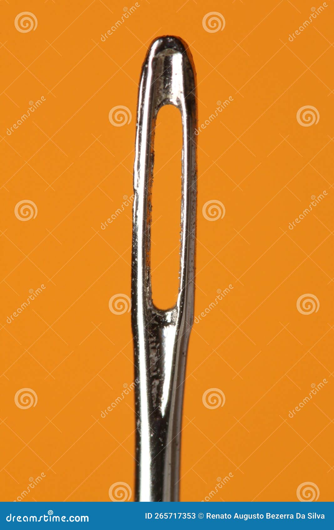 Hand Sewing Needle of Gray Color on an Orange Background Stock Image ...