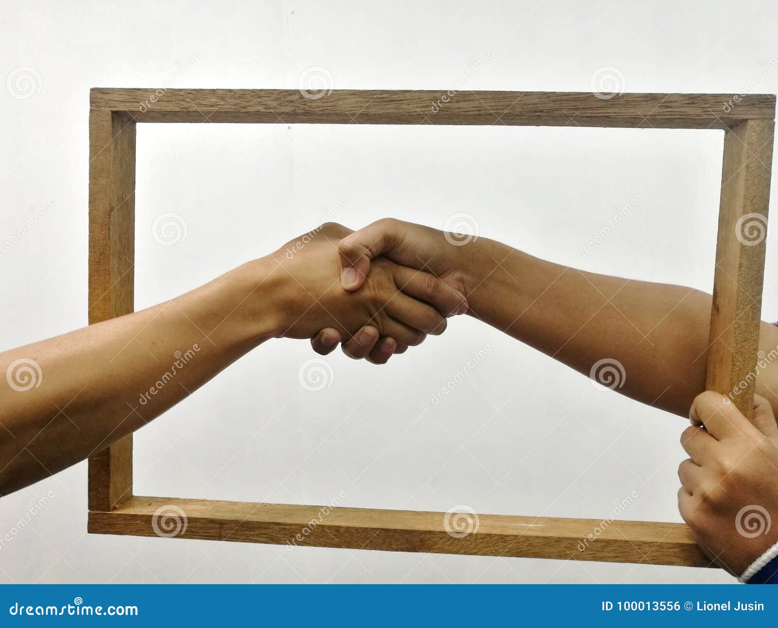 Hand Shake Inside a Wooden Frame Stock Photo - Image of making, wooden ...