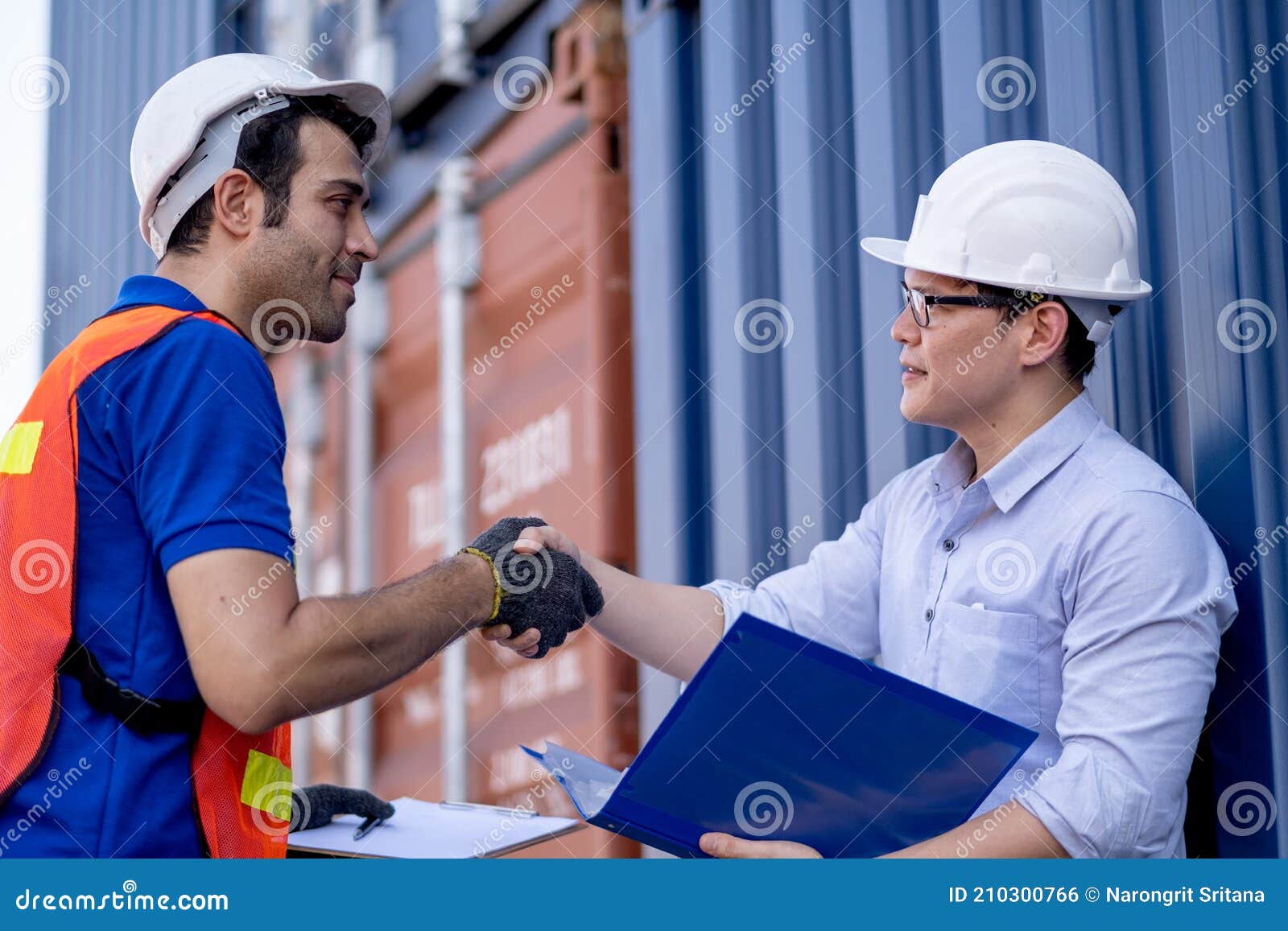 Hand Shaking Of Cargo Container Worker Or Engineer And They Smile With