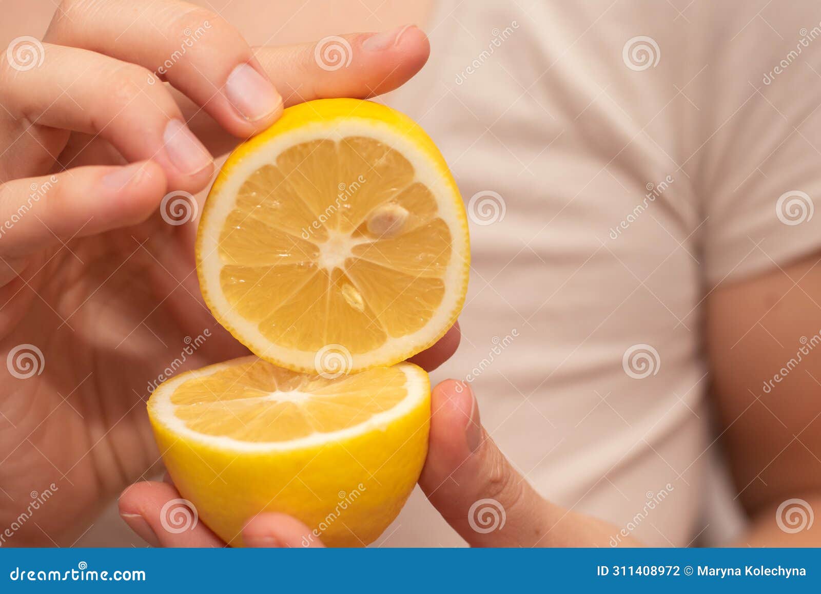 Hand Showcasing Half a Lemon. a Person& X27;s Fingers Displaying a ...