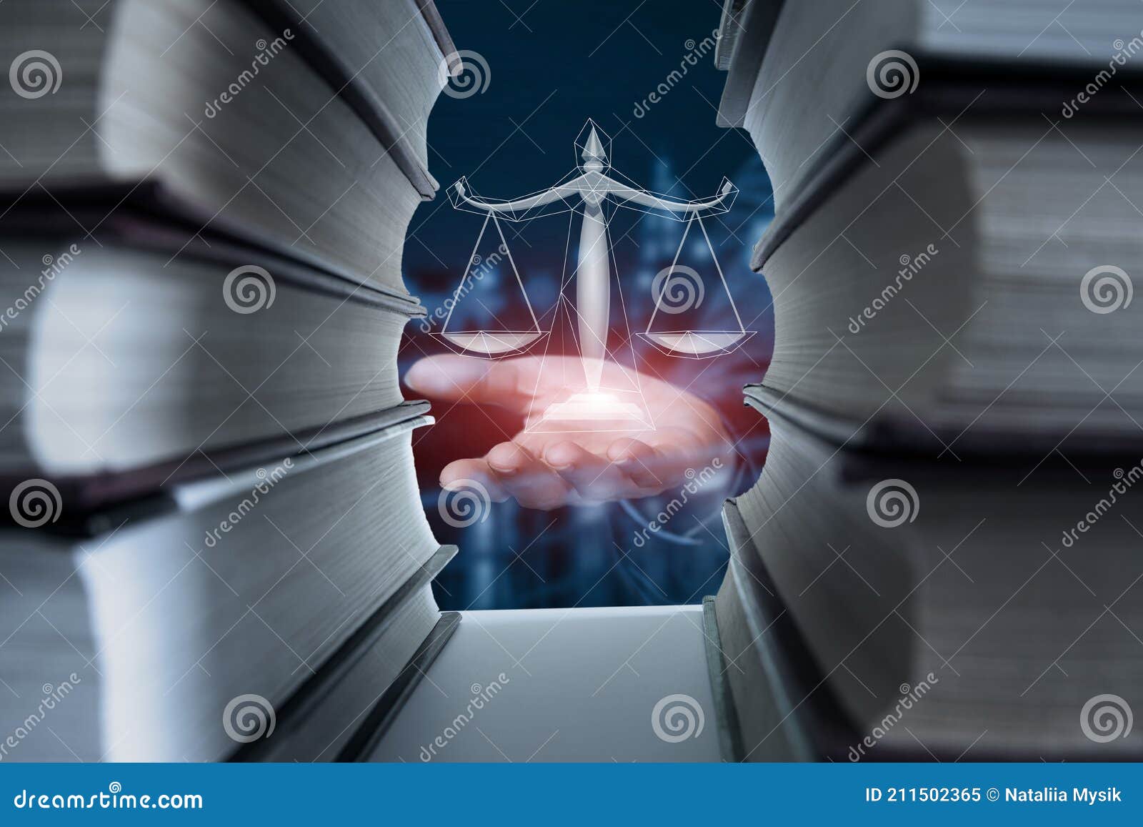 Hand Shows the Scales of Justice between the Books Stock Image - Image ...