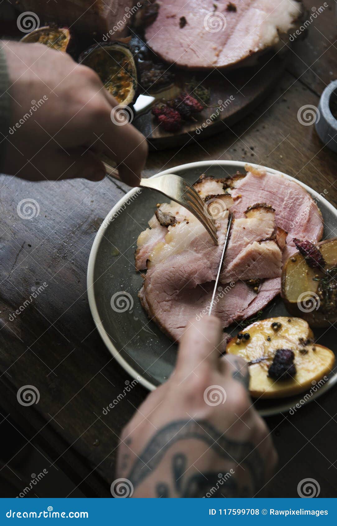 Hand slicing piece of ham stock photo. Image of hand - 117599708
