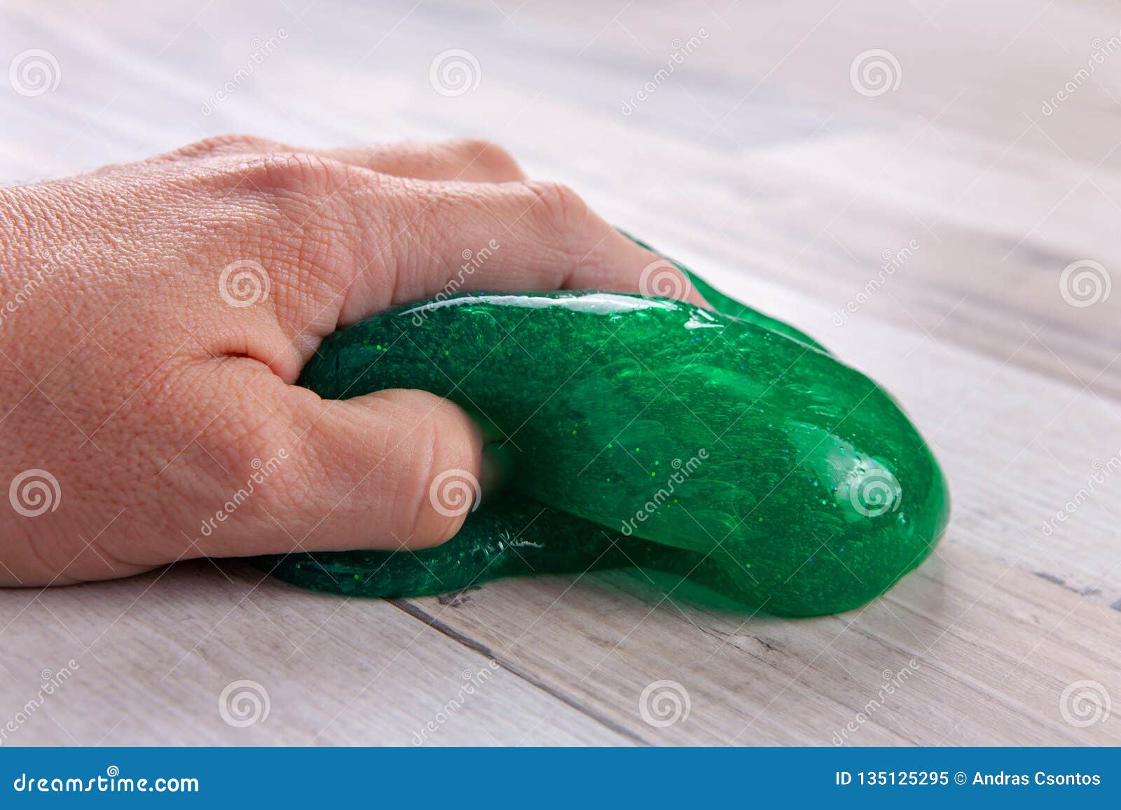 Hand with slime on a table stock image. Image of elastic - 135125295