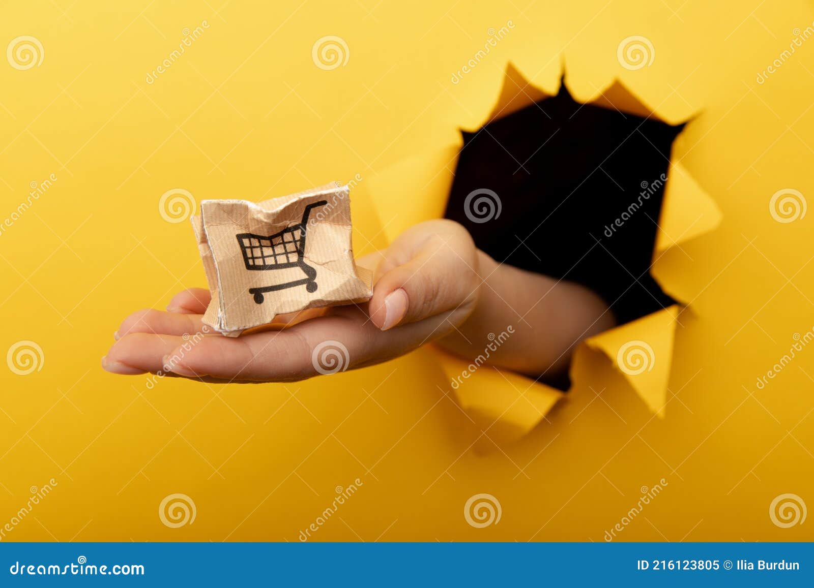 Hand with a Small Broken Delivery Box through a Yellow Paper Hole ...