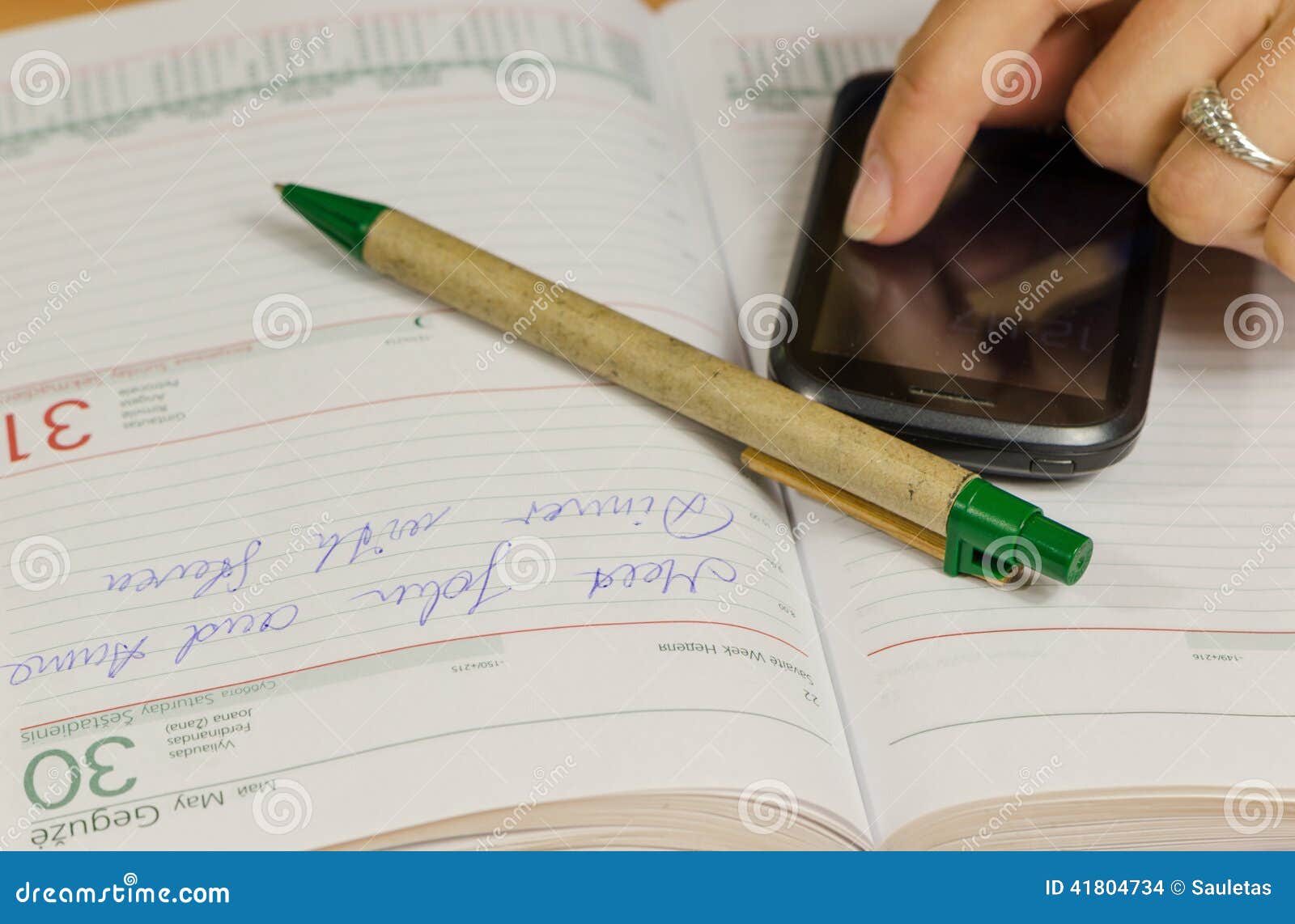 Hand with Smart Phone and Business Planner Diary Stock Photo - Image of ...