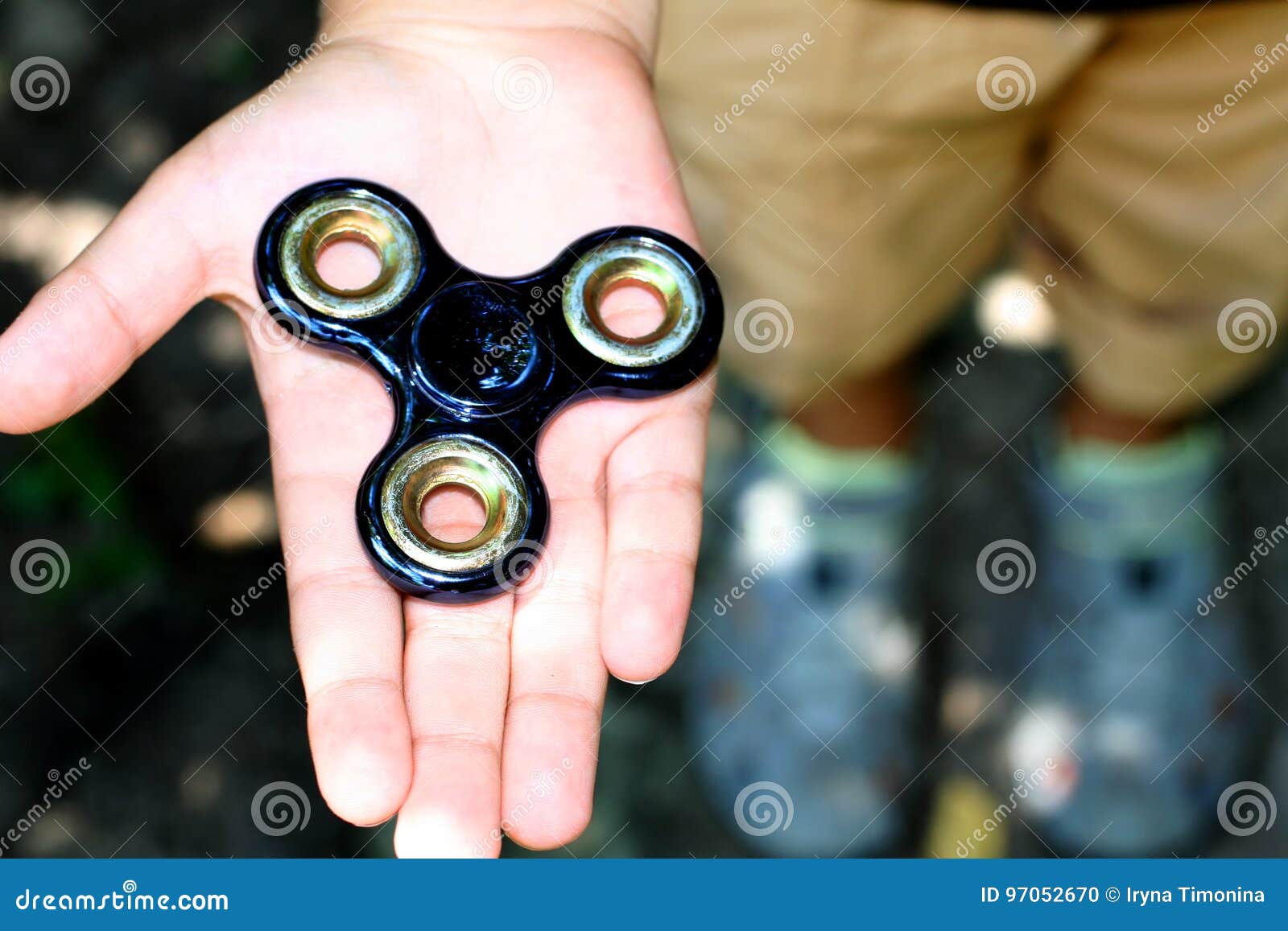 Hand Spinner or Fidgeting Spinner Rotating on Child`s Hand Stock Photo ...